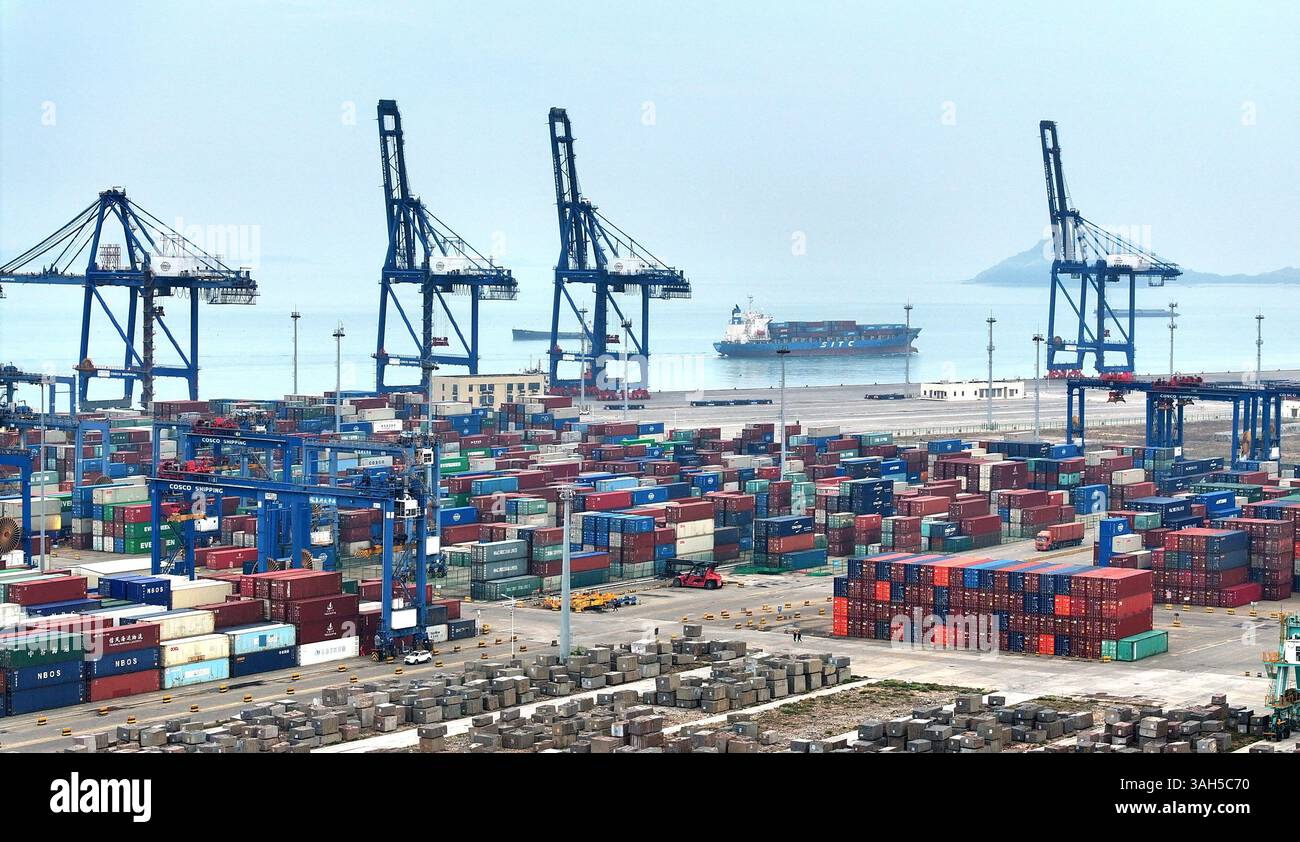 SHISHI, CHINA - APRIL 5, 2025 - Cargo ships load and unload containers ...
