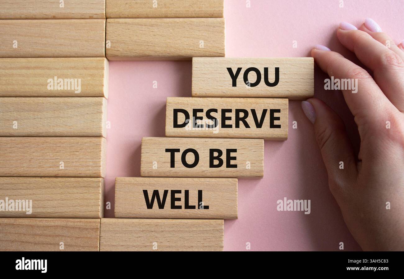 You deserve to be well symbol. Wooden blocks with words You deserve to ...