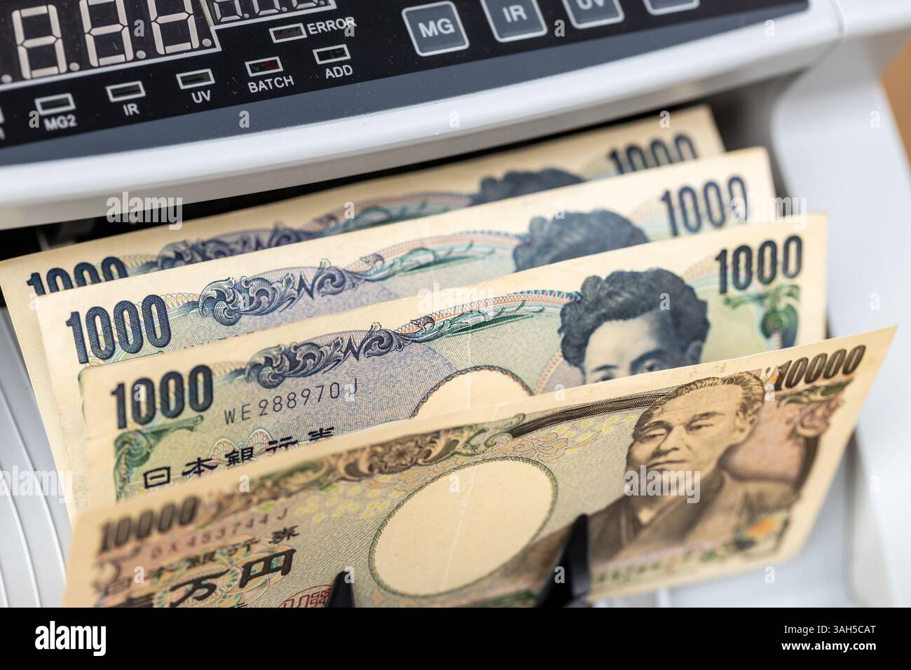 Japan money, Japanese yen counting machine. Financial background ...
