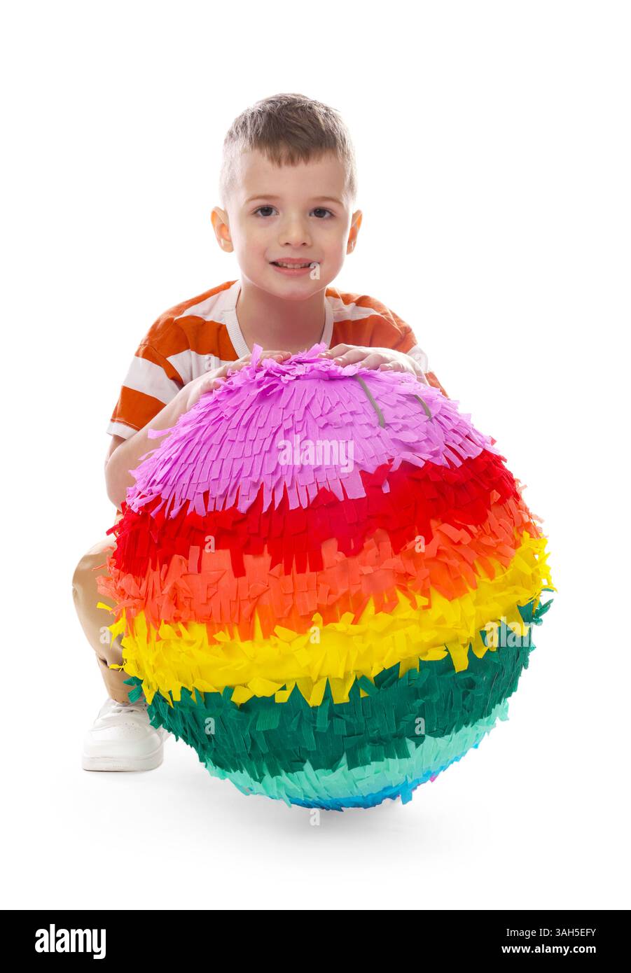 Happy boy with colorful pinata on white background Stock Photo - Alamy