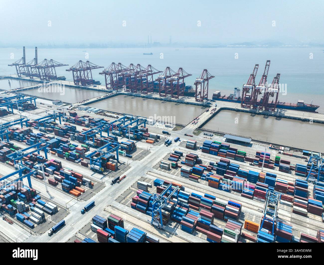 Ningbo, China. 06th Apr, 2025. Driverless trucks transfer containers at ...