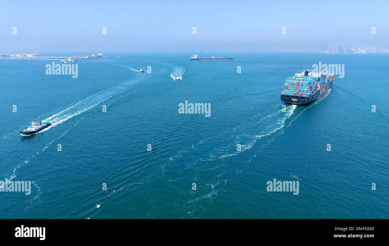 Cargo ships are seen on the outer channel of Qingdao Port in Shandong ...