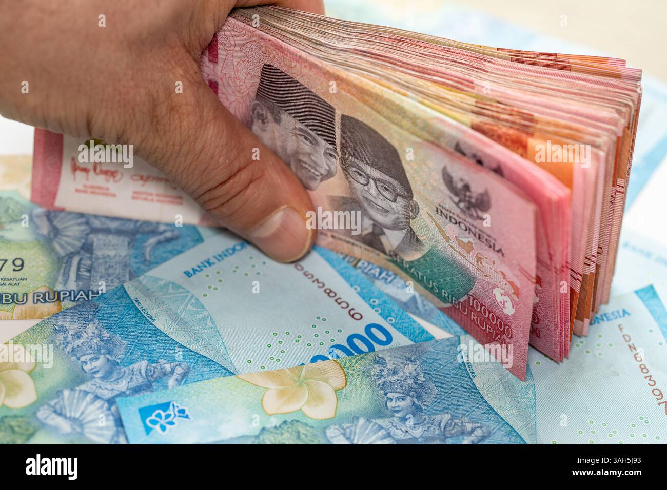 Indonesia money. Financial success concept. hand holding big bundle of ...
