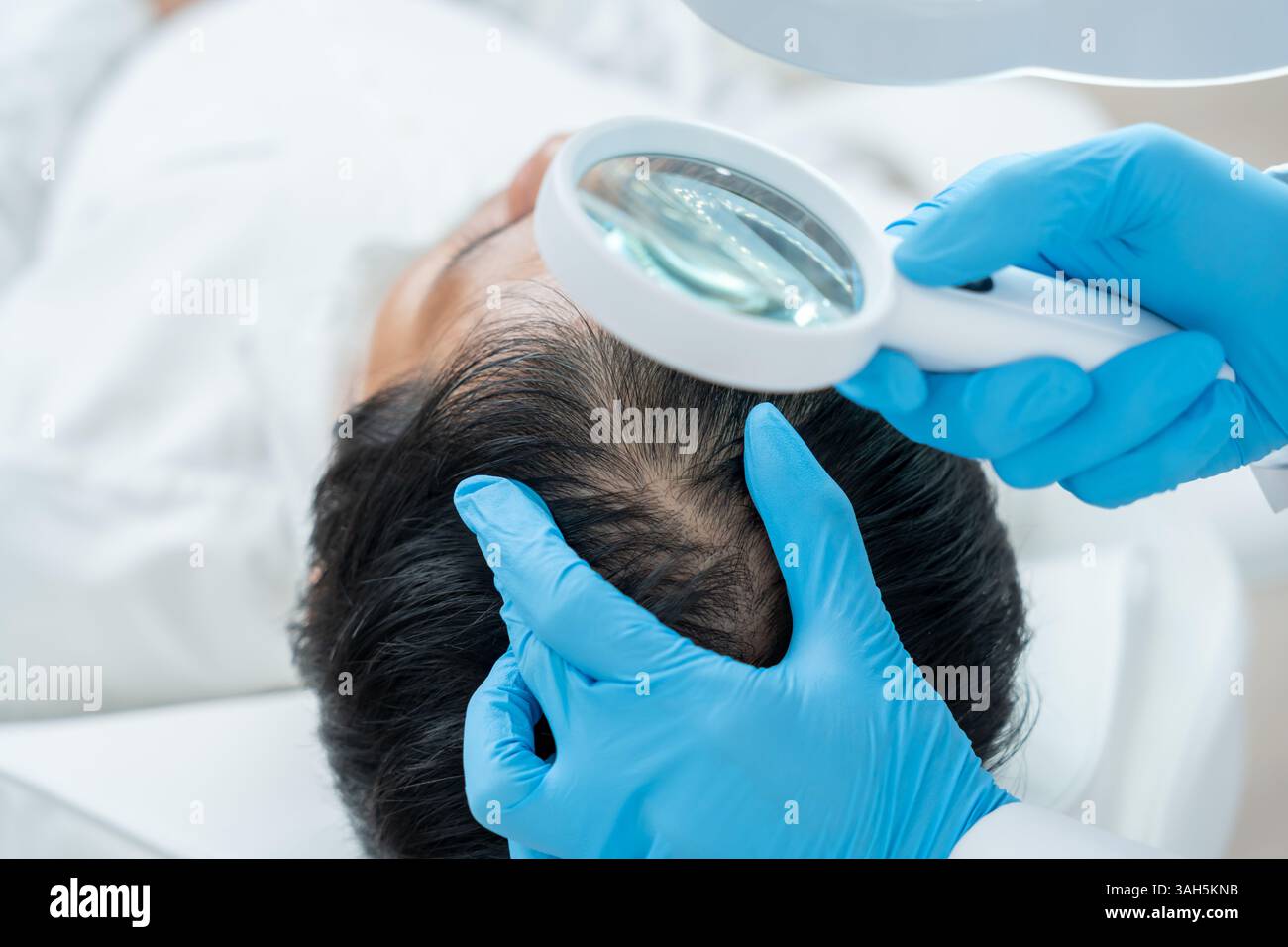 Specialist of hair check health of hair for Asian man, damaged hair ...