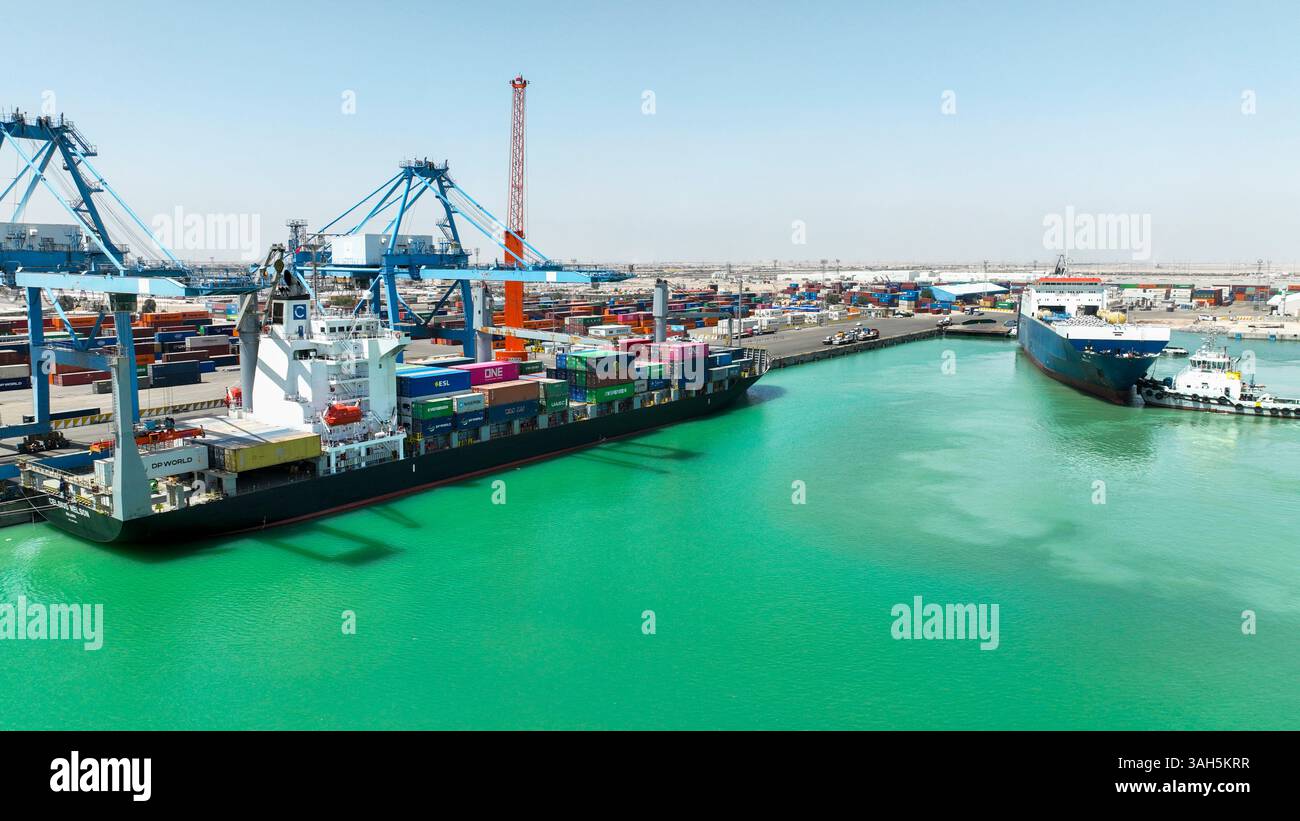 This aerial photo shows containers and moored boats at the port of Umm ...