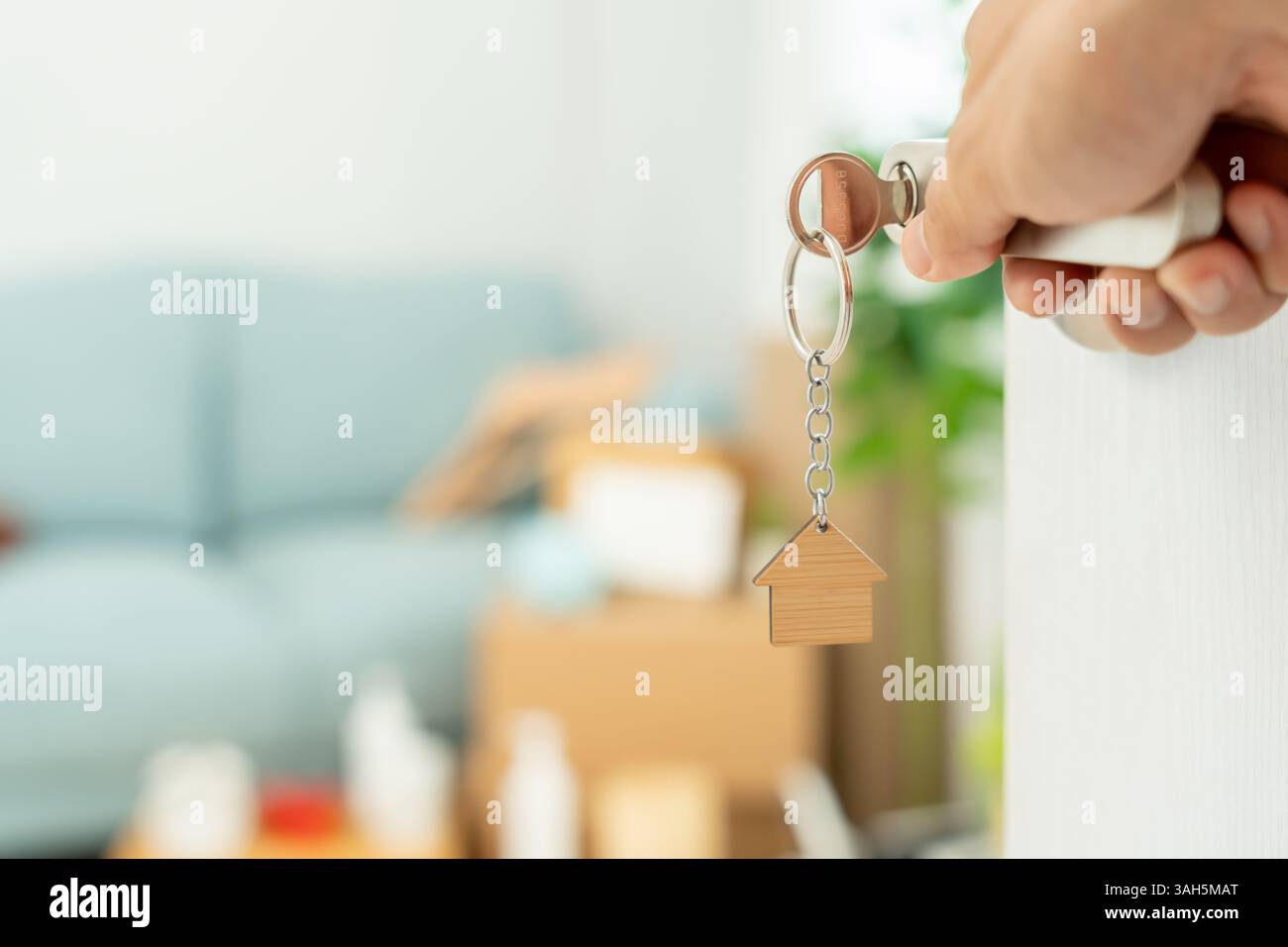 Moving house, relocation. Couple hold key house keychain in new ...