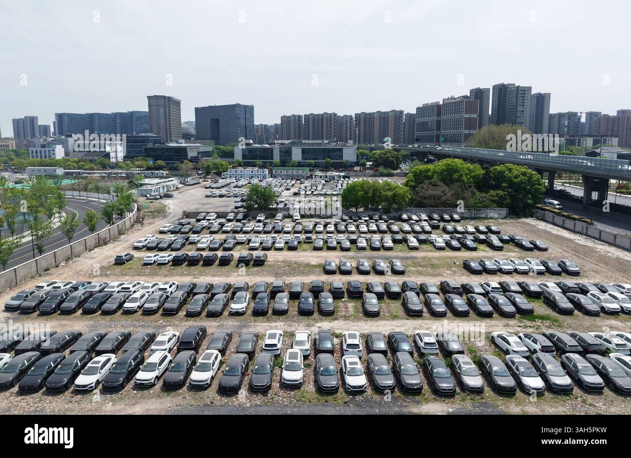 HANGZHOU, CHINA - APRIL 9, 2025 - Cars are parked at a temporary ...