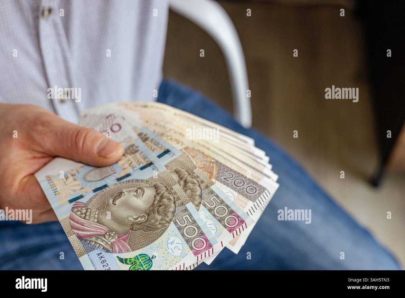 Poland Money. Man holding out his hand with Polish banknotes. Lots of ...