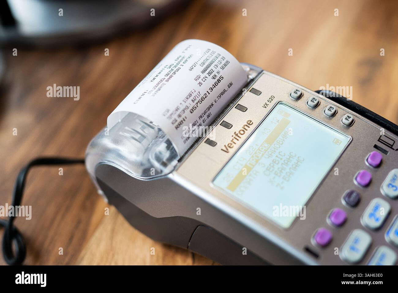 Close-up of a POS payment terminal Verifone VX 520 printing a receipt ...