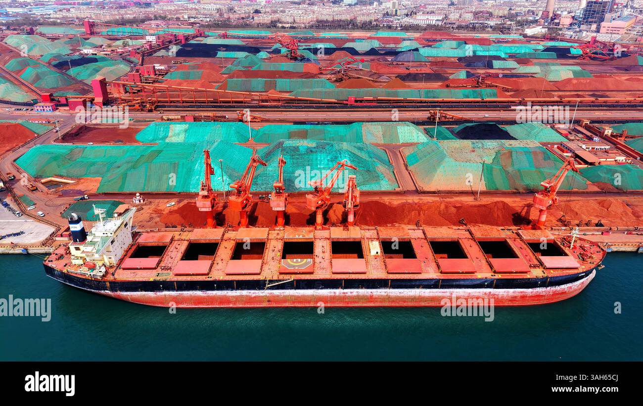 QINGDAO, CHINA - APRIL 9, 2025 - A cargo ship offloads imported iron ...