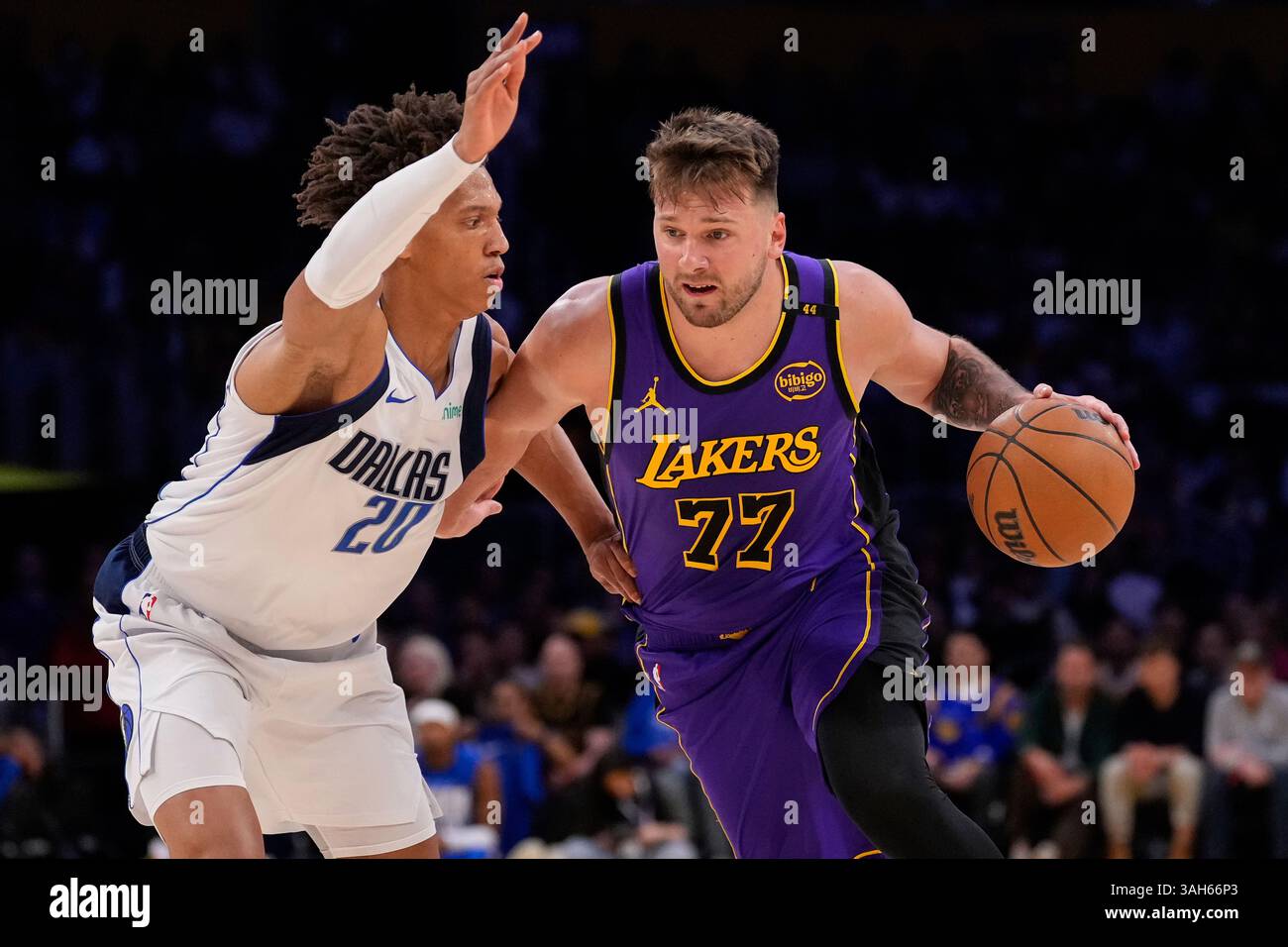 FILE - Los Angeles Lakers guard Luka Doncic, right, moves the ball ...