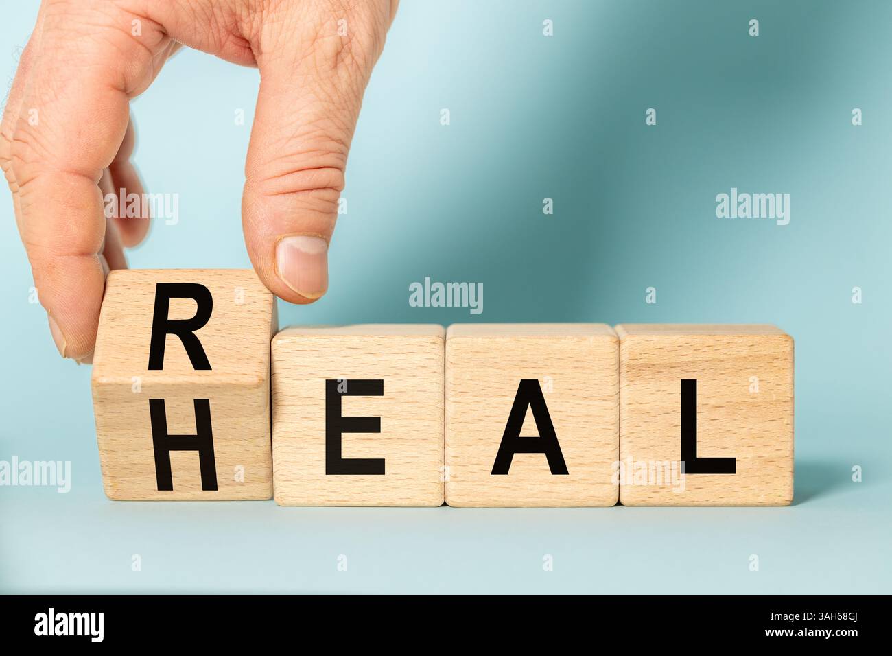 I turn over the wooden cube with the words 'Real heal'. Medical and ...
