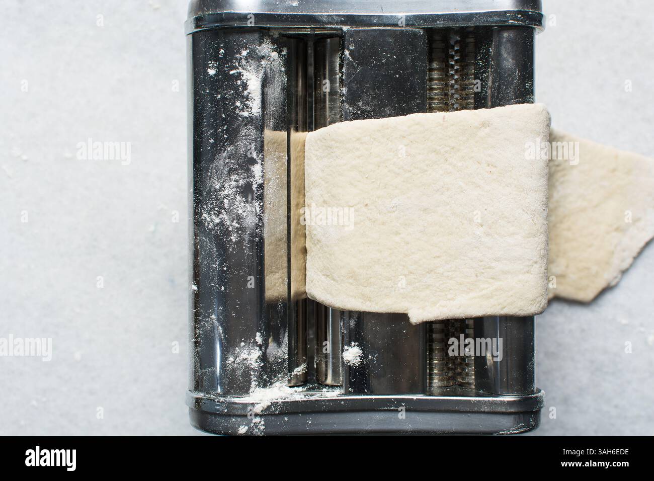 Overhead view of dumpling wrappers dough being rolled out, process of ...