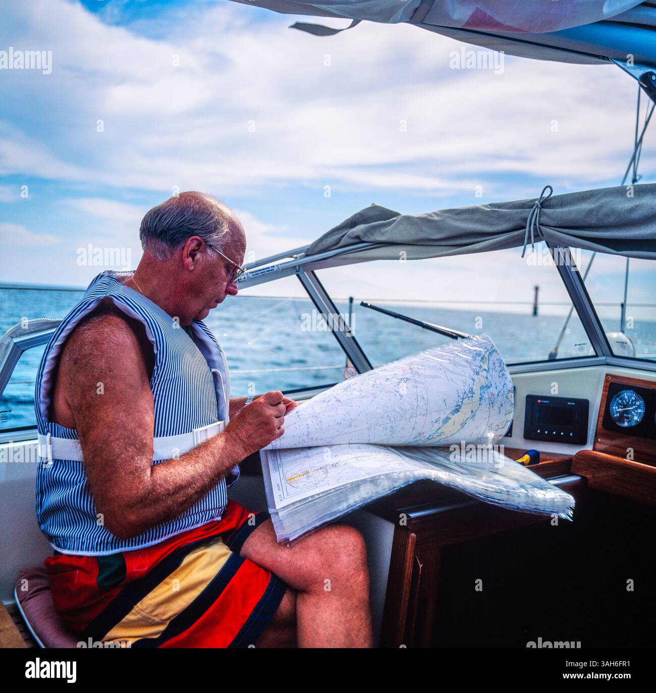 Sailor reading chart Stock Photo - Alamy
