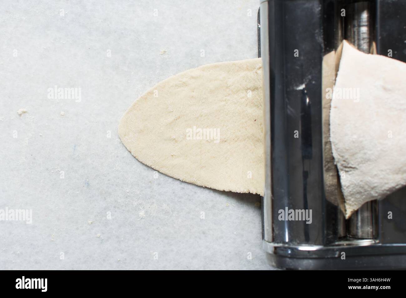 Overhead view of dumpling wrappers dough being rolled out, process of ...