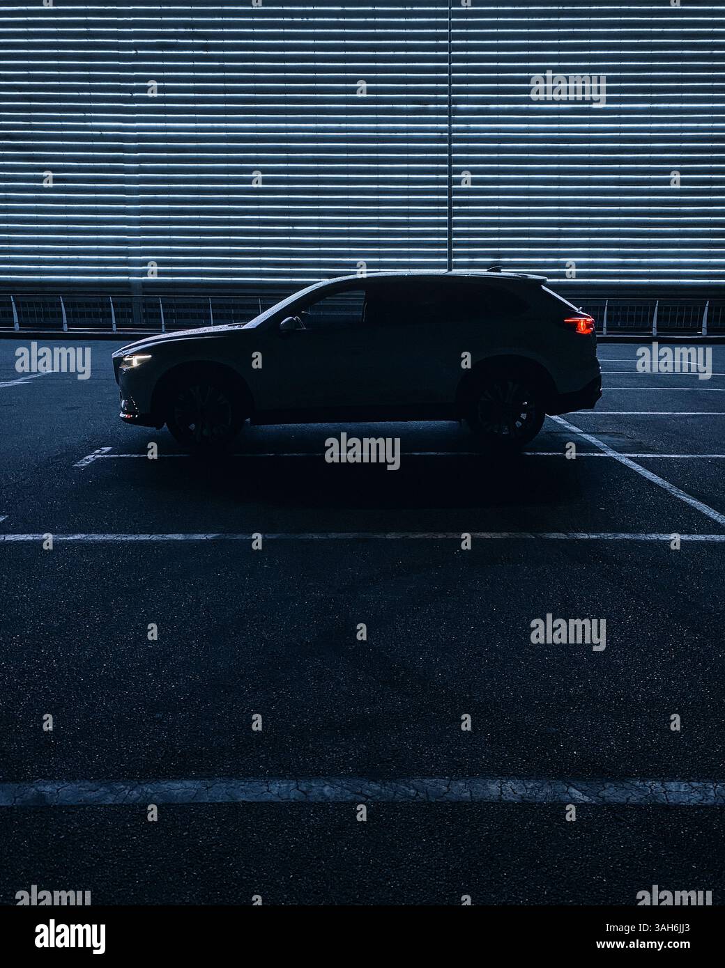 Mazda CX-9 in parking lot at night - dark silhouette. Side view of ...