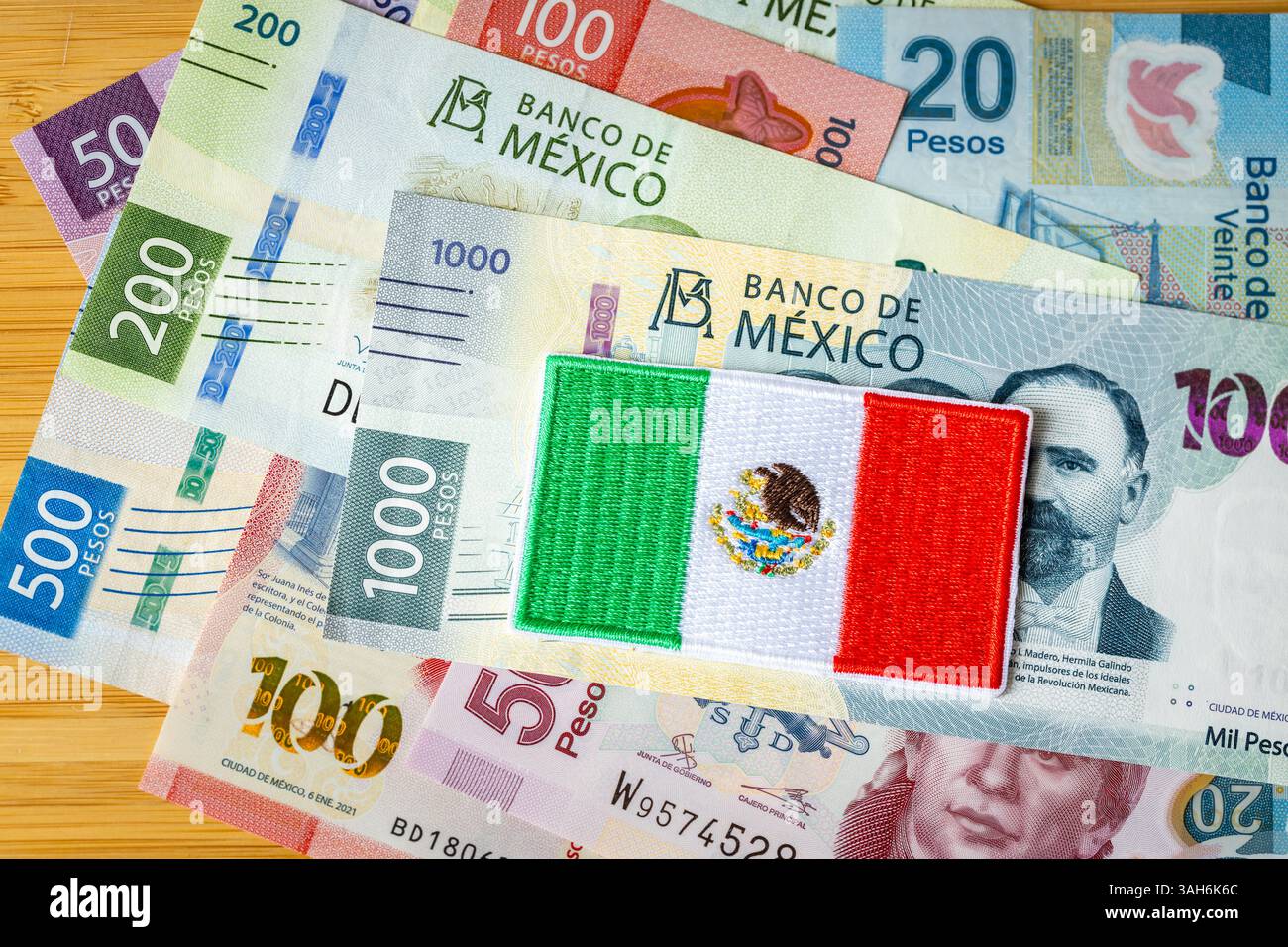 Mexico symbol lying on a bundle of Mexican pesos, financial concept ...