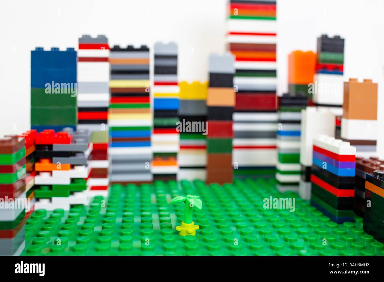 Defocused building blocks towers background on green desk , abstract ...