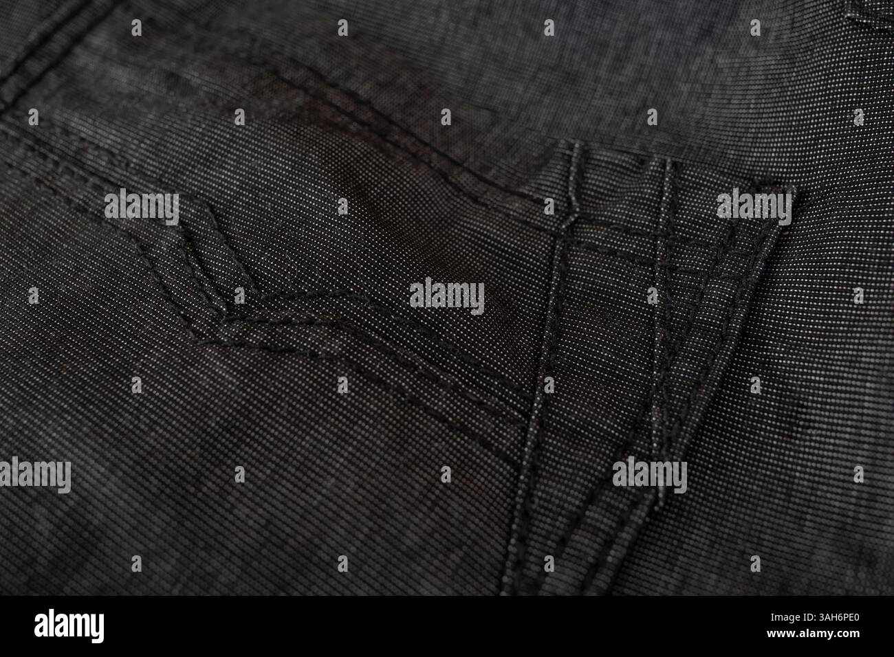 Black jeans texture with sewing pattern back pocket, abstract close up ...