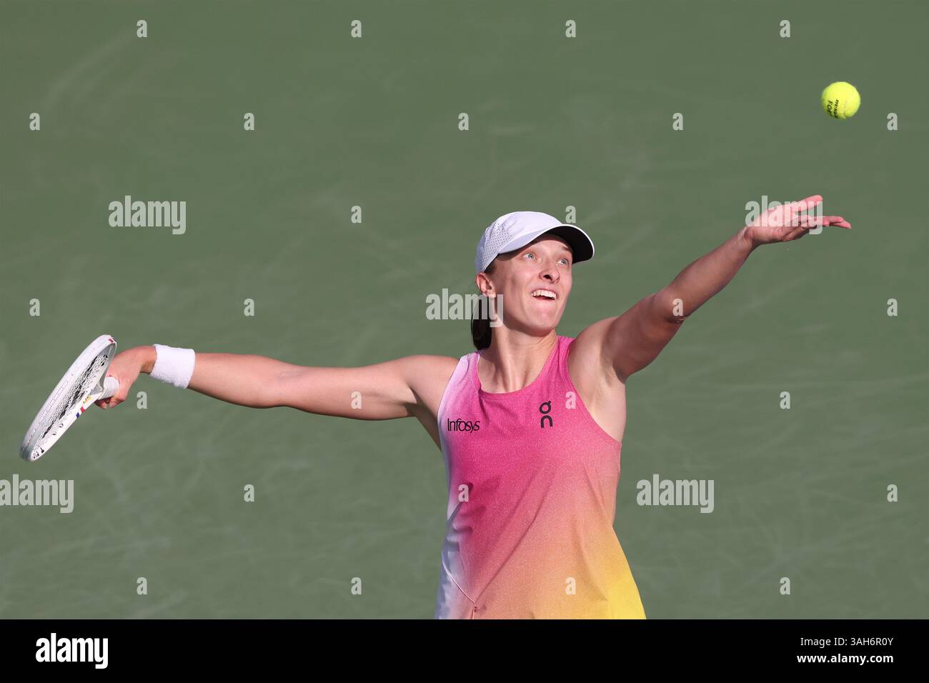 Polish tennis player Iga Swiatek playing a service shot at the 2025 ...