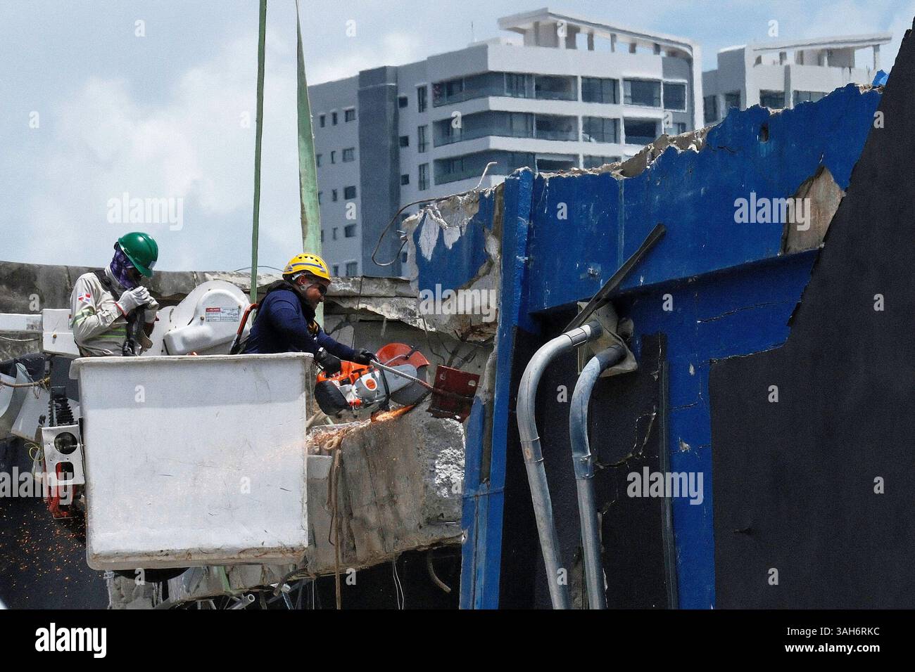Rescue workers cut a wall while searching for survivors at the Jet Set ...
