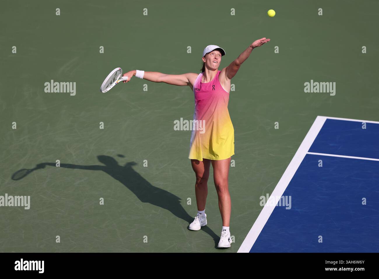 Polish tennis player Iga Swiatek playing a service shot at the 2025 ...