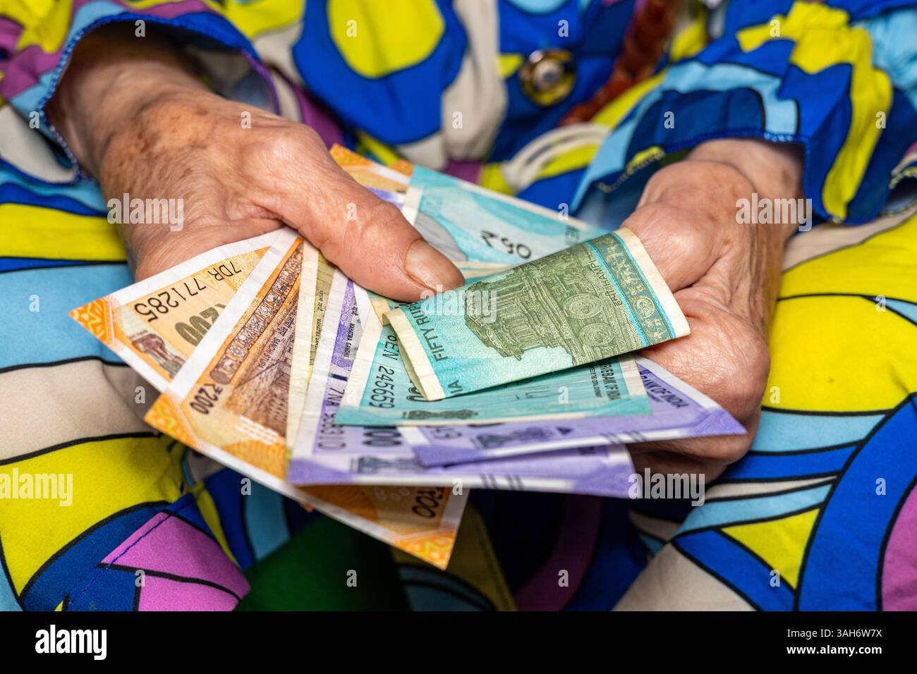 India money. Indian senior woman holding Indian rupees in her hands ...