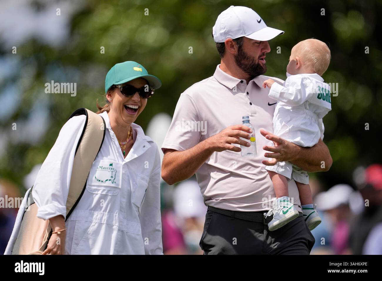 Scottie Scheffler holds his son Bennett as wife Meredith laughs during ...