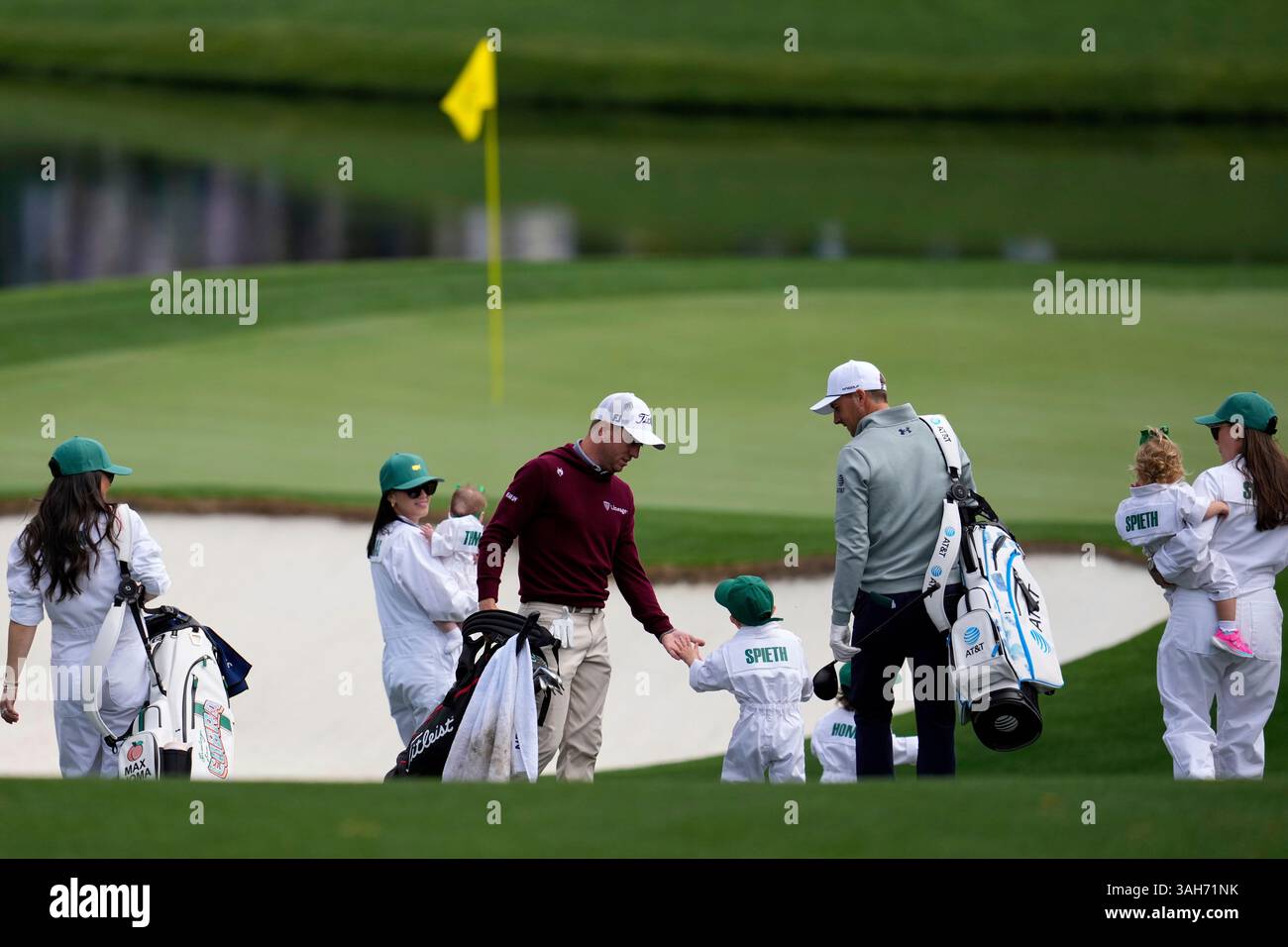 Jordan Spieth, right, holds his son Sammy's hand as he gives five to ...
