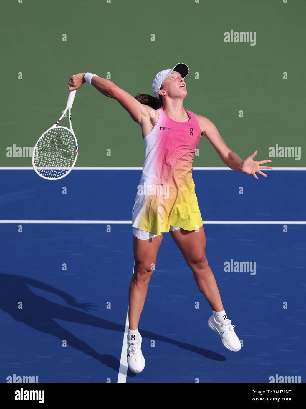 Polish tennis player Iga Swiatek preparing to play a smash at the 2025 ...