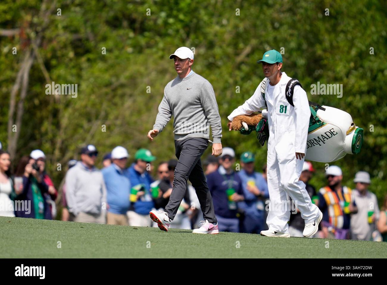 Rory McIlroy, of Northern Ireland, walks with caddie Harry Diamond on ...