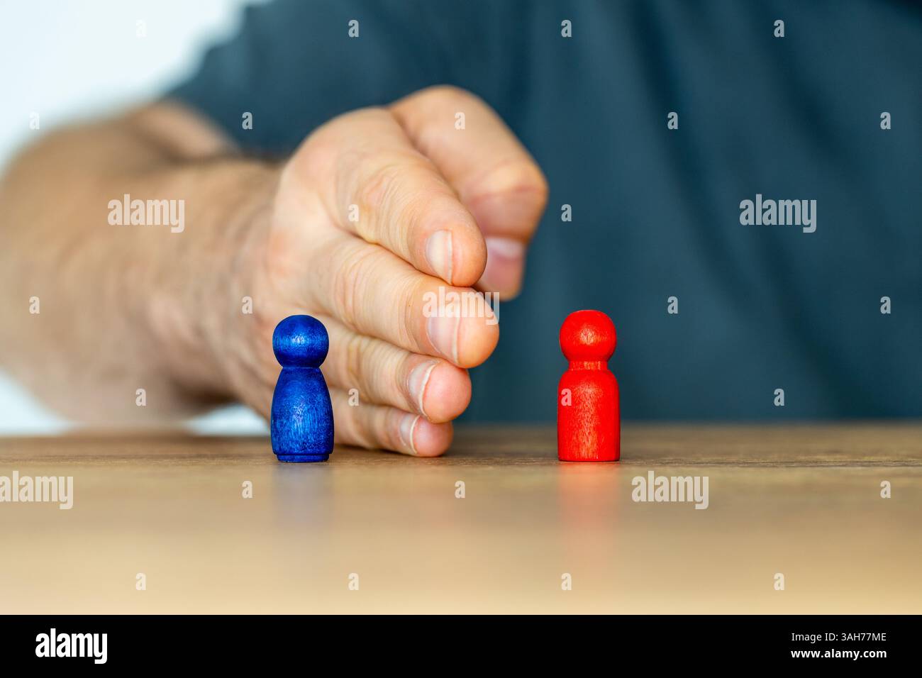 Person holds hand between two wooden figures. Soft skills and conflict ...