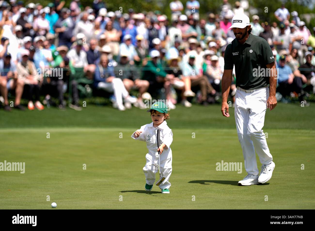 Max Homa and his son, Cam Homa, walks on green on the seventh hole ...
