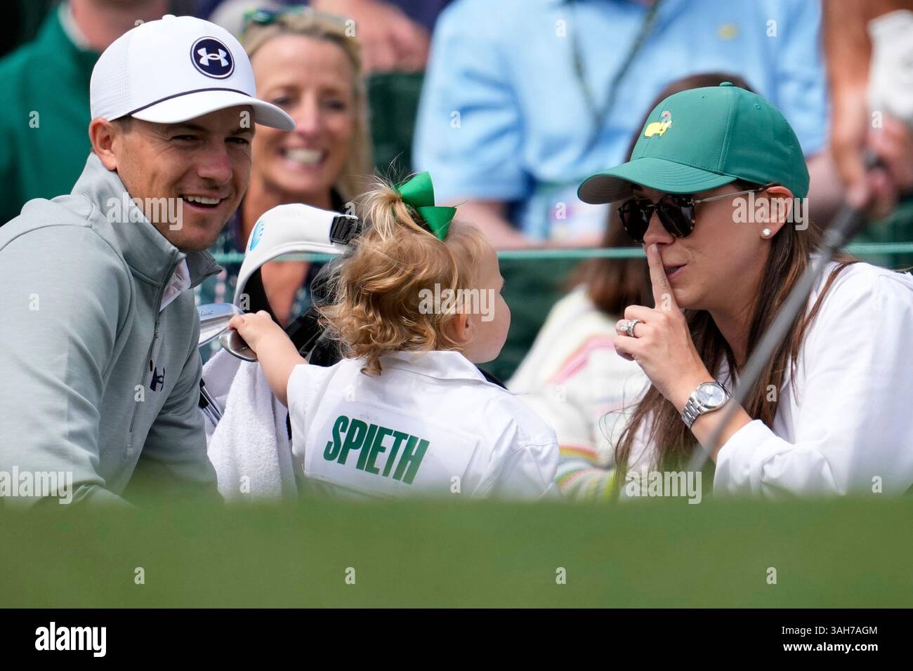 Jordan Spieth and wife Annie Verret interact with daughter Sophie as they wait to play on the ...