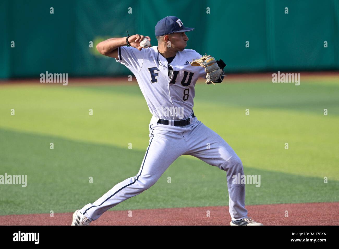 Florida International infielder Adonys Velez (8) throws during an NCAA ...