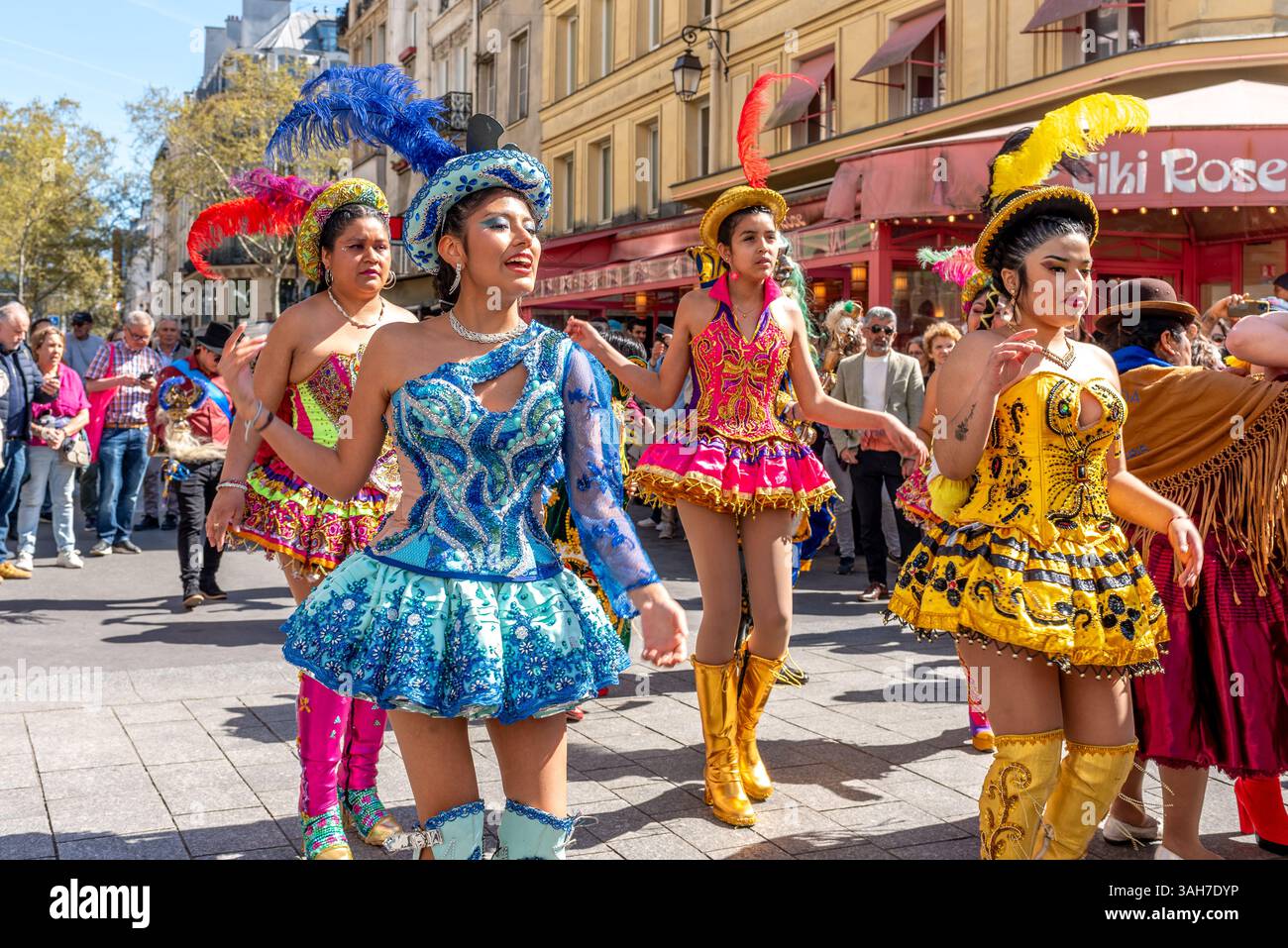 Bolivian women in vibrant coloured costumes, singing and dancing at the ...