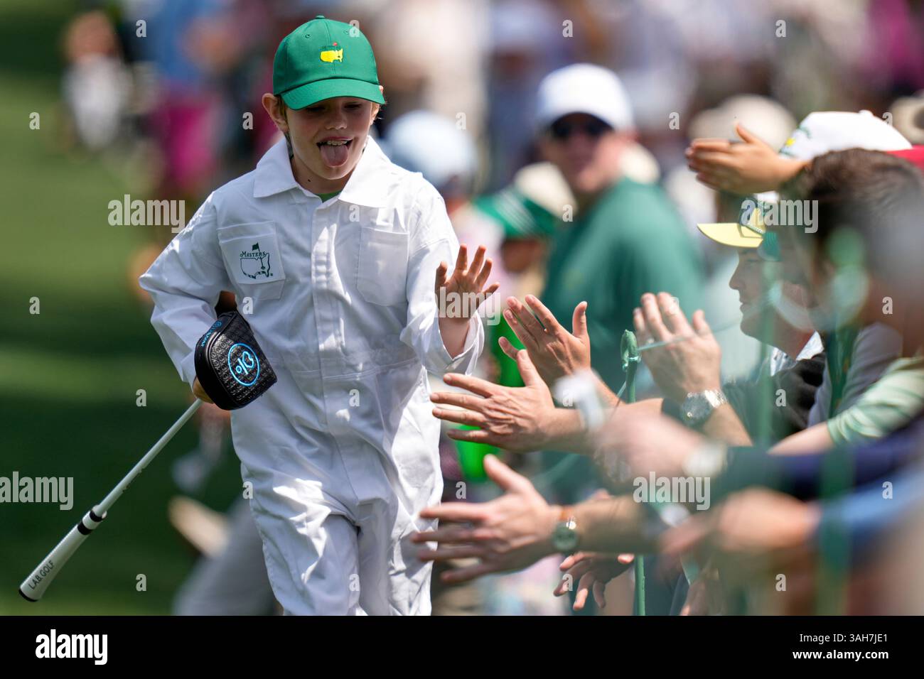 Lucas Glover's son, Lucas Jr., high fives patrons on the first hole ...