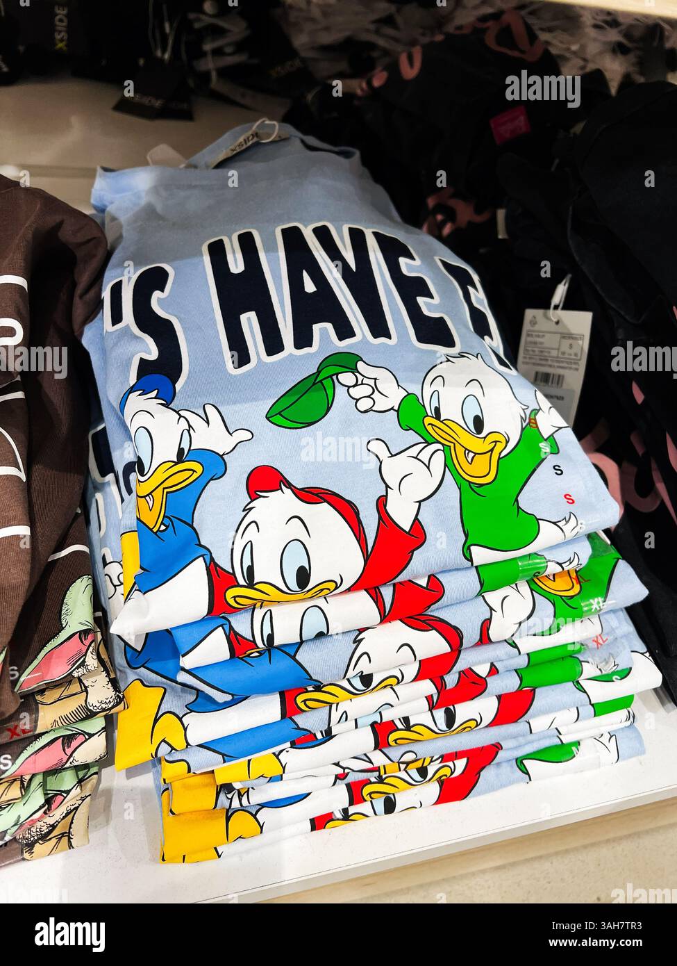 Kyiv, Ukraine - April 08, 2025: Stacked t-shirts with bright Donald ...