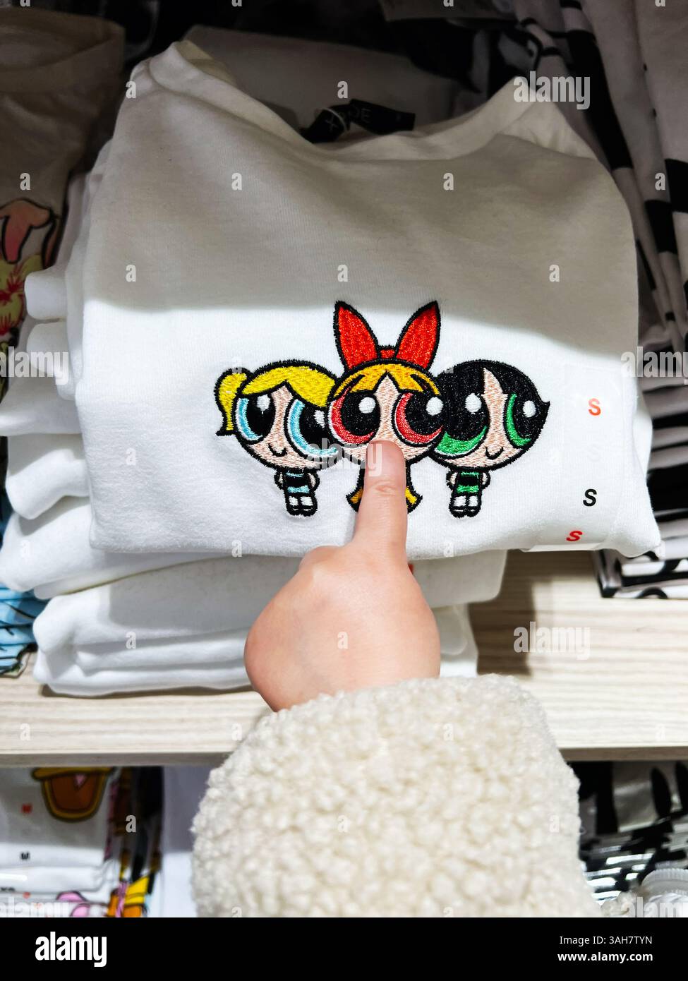 Kyiv, Ukraine - April 08, 2025: Child hand touching The Powerpuff Girls ...