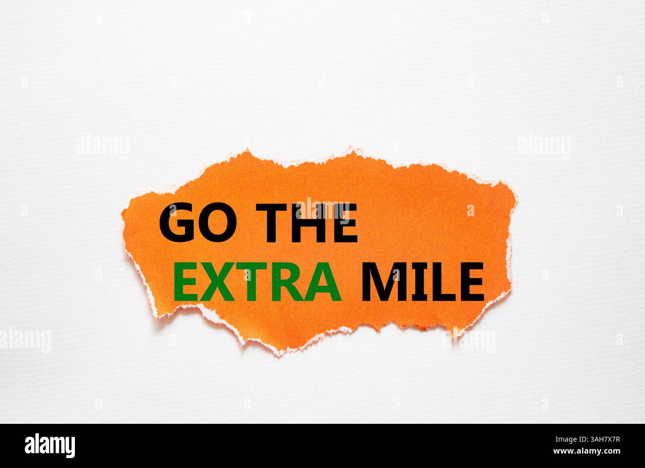 Go the extra mile symbol. Torn orange paper with words Go the extra ...