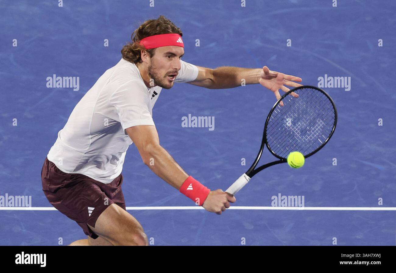 Greek tennis player Stefanos Tsitsipas playing a backhand volley at the ...