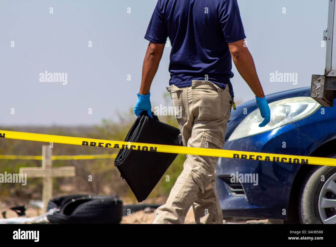 Forensic investigators work at crime scenes in Mexico, documenting ...