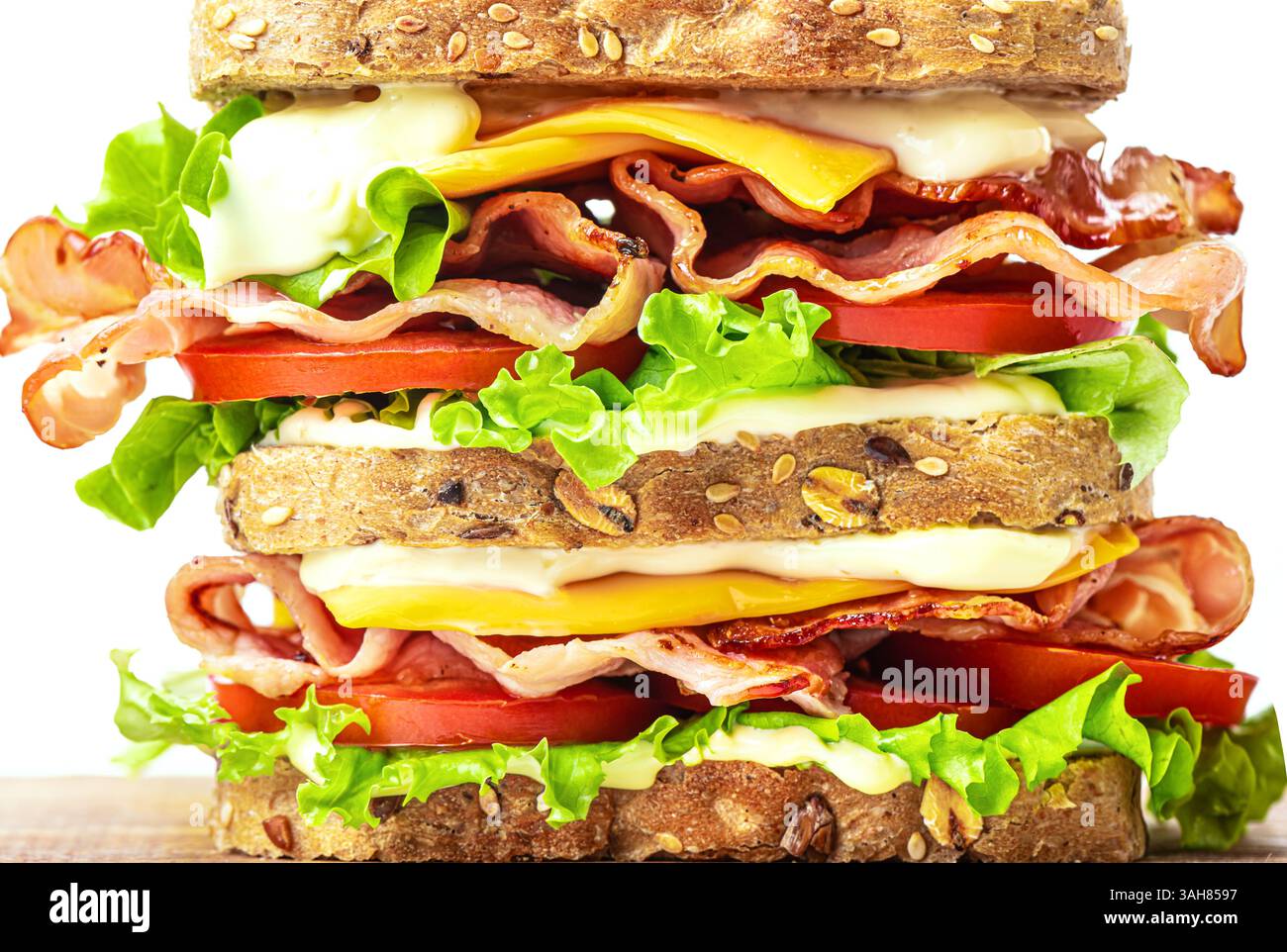 Double BLT sandwich with cheddar cheese on white background, extremely ...