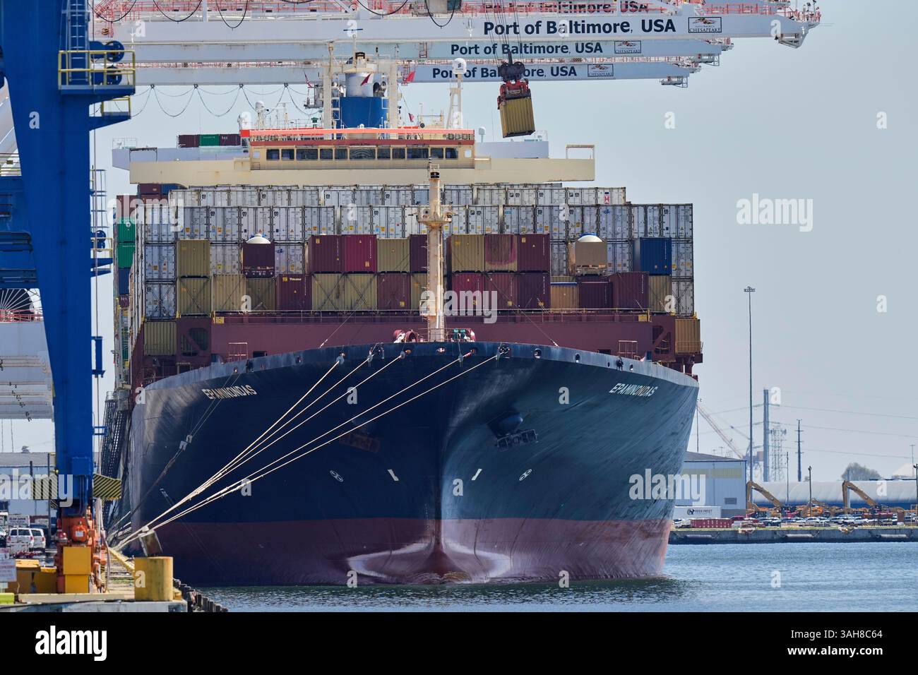 A crane lifts an imports container from the cargo ship Epaminondas ...