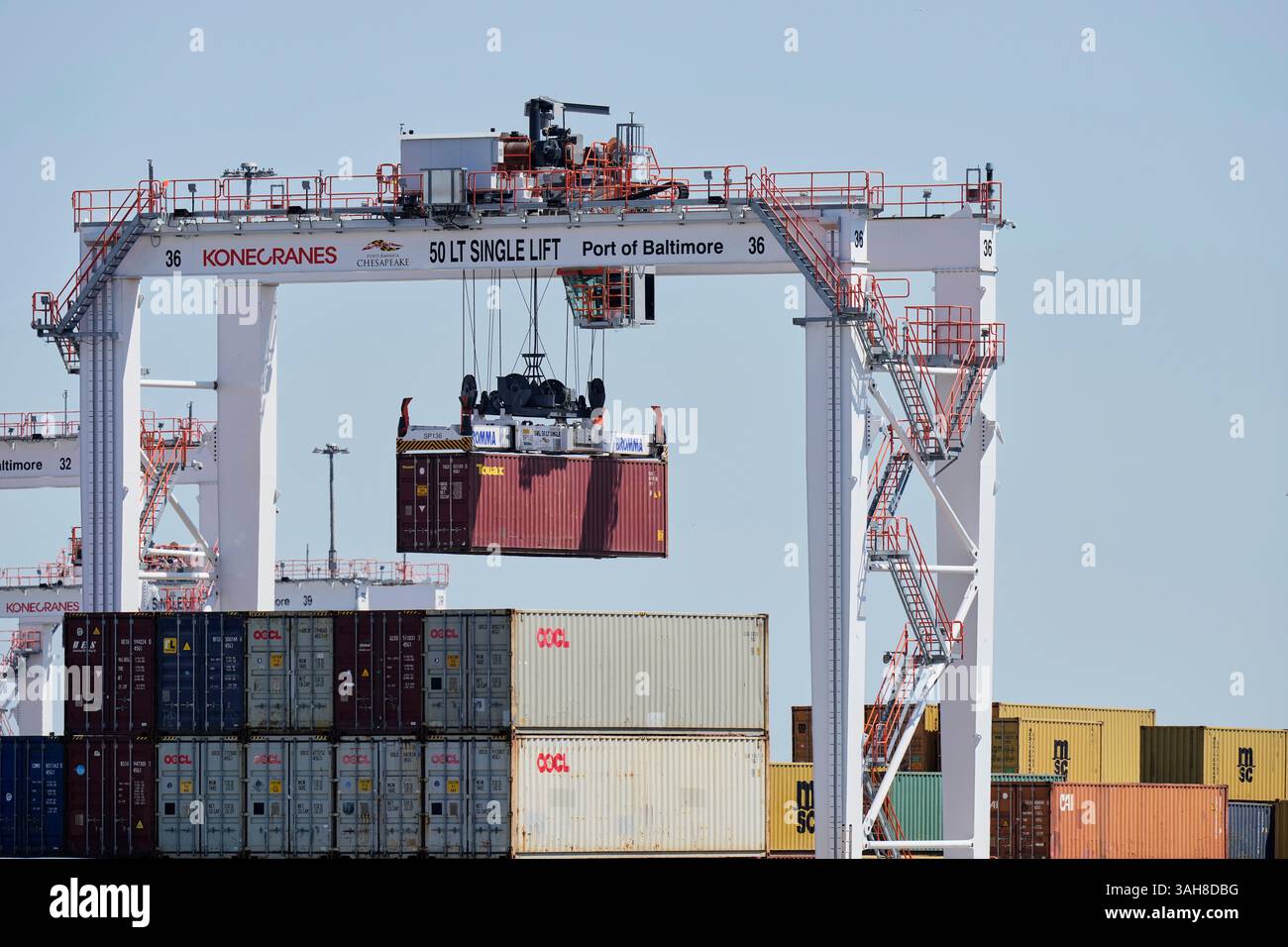 A crane lifts a container at the Port of Baltimore, Wednesday, April 9 ...