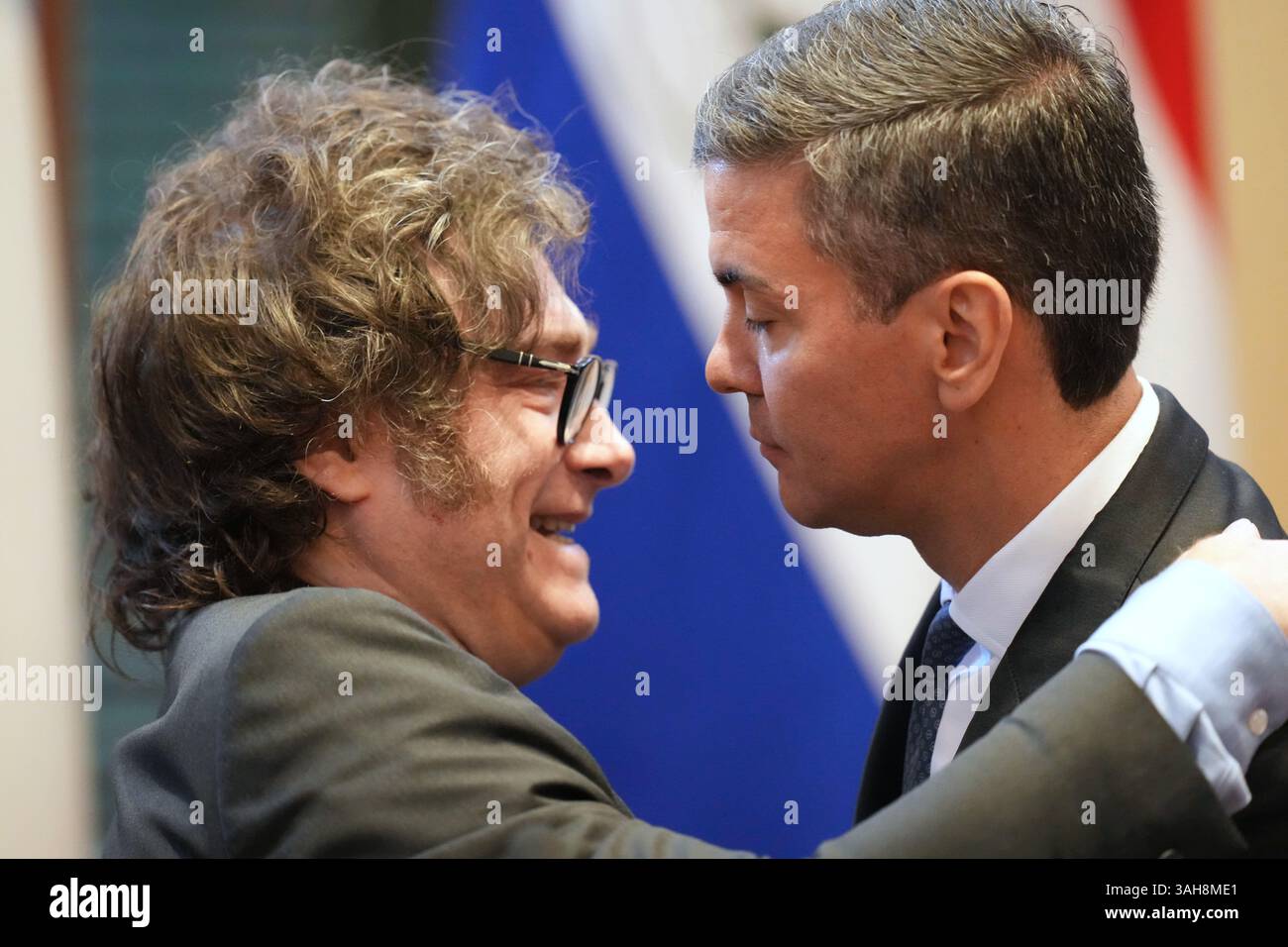 Paraguayan President Santiago Peña, right, is embraced by Argentina's ...