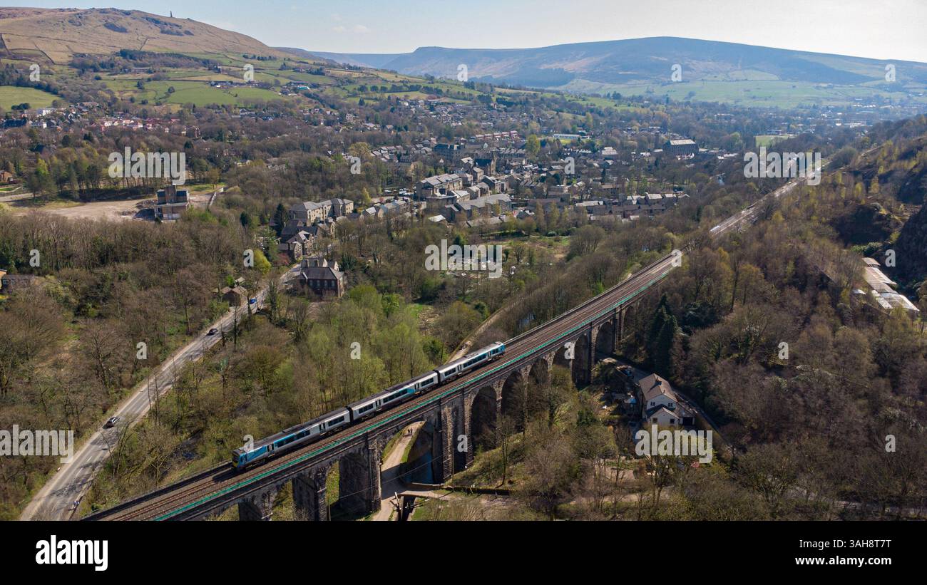 A Transpennine railway service makes its way over Uppermill Viaduct in ...