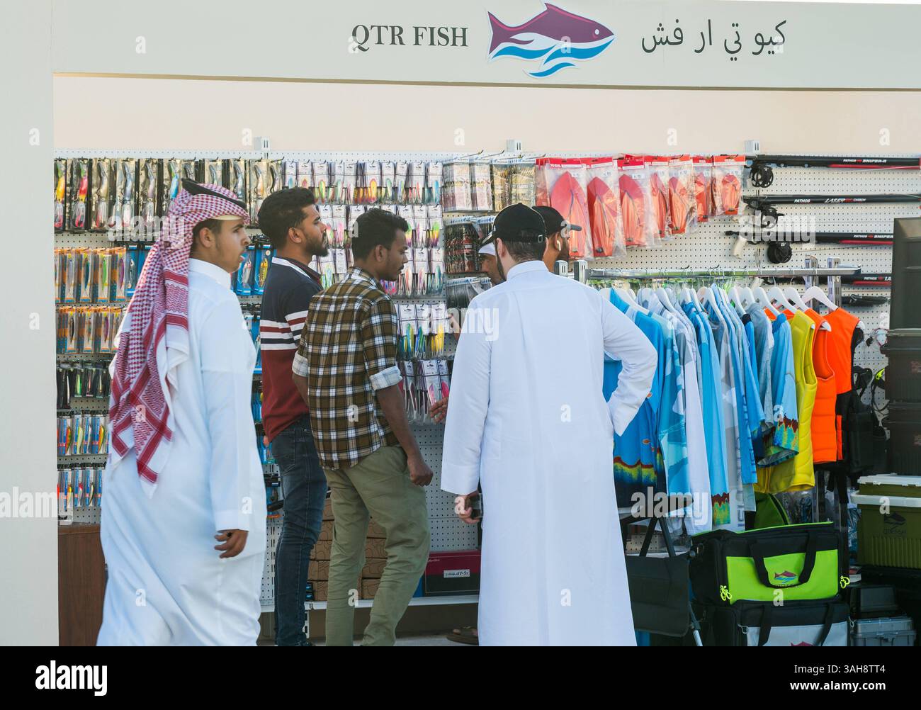 FIRST FISHING EXHIBITION IN QATAR People visit a stall selling fishing ...