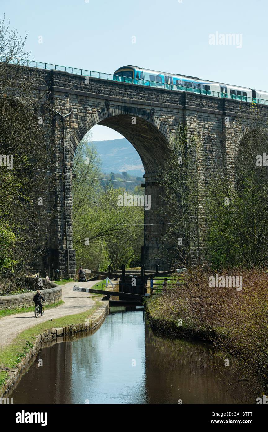 A Transpennine railway service makes its way over Uppermill Viaduct in ...