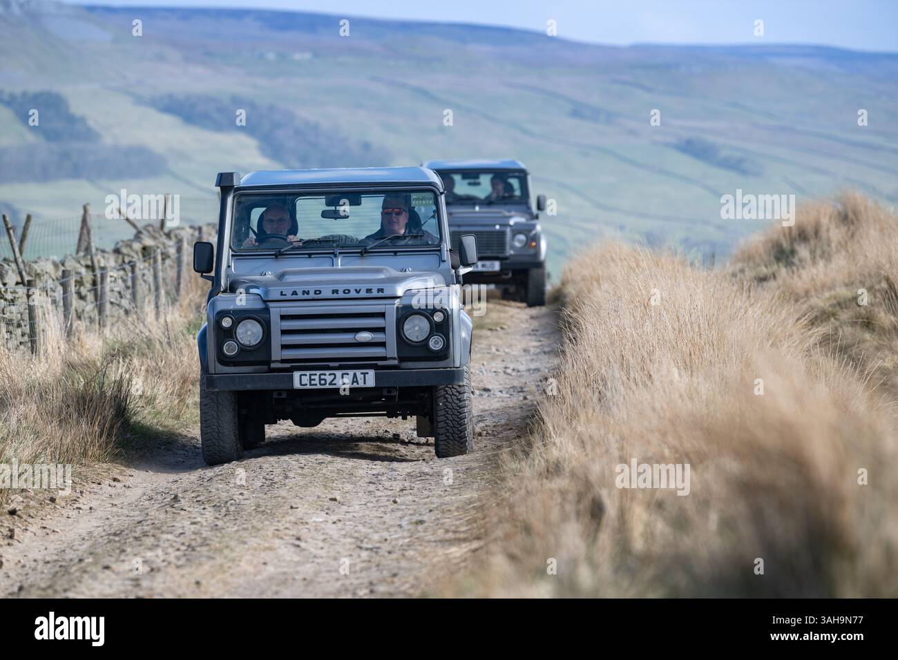 Land Rover Defenders travelling down some rough Green Lanes in the ...